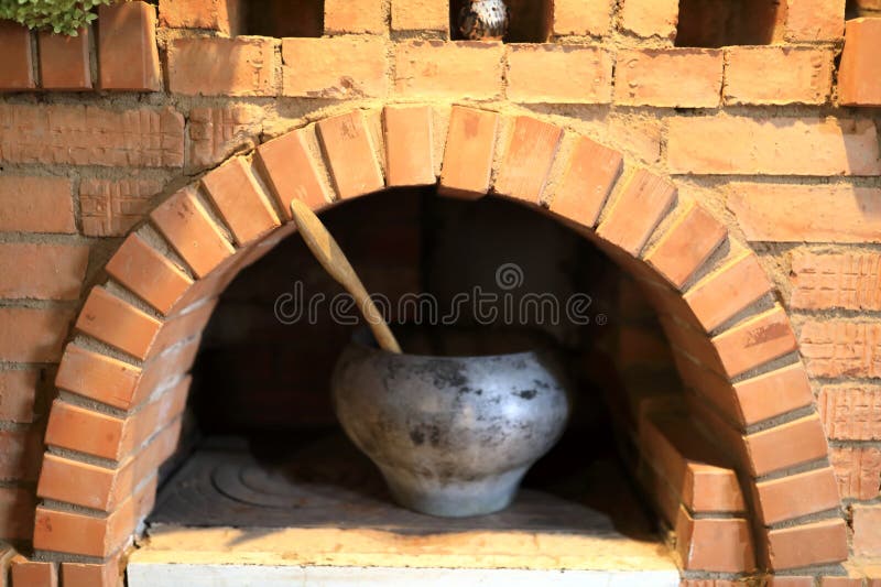 Pot in brick stove stock image. Image of background - 131693363