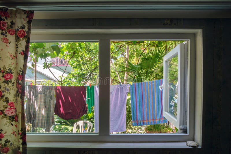 Washed Laundry Hanging on a Clothesline through a Window Stock Image ...
