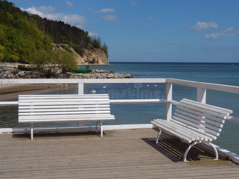 View of White Benches on Beach Surrounded by Water Stock Photo - Image ...