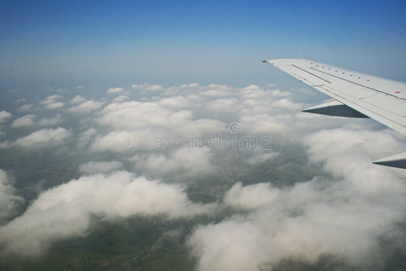 Wing of Passenger Jet Aircraft Over Loose Clouds Stock Photo - Image of ...