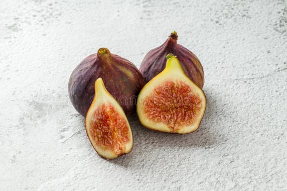 View of Whole and Cut Organic Figs on Stone Table Stock Photo - Image ...