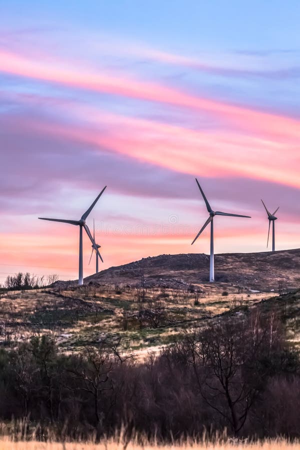 View of a Wind Turbines on Top of Mountains, Dramatic Sunset Sky Stock ...
