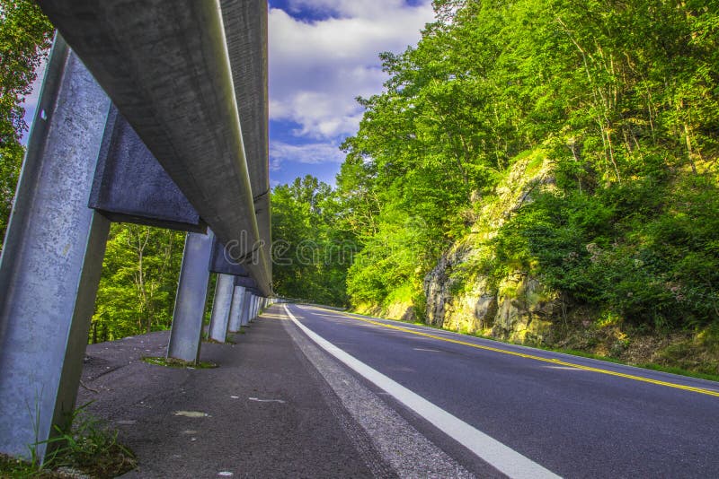 View of a Winding Mountain Road from Behind a Guard Rail Low Stock ...