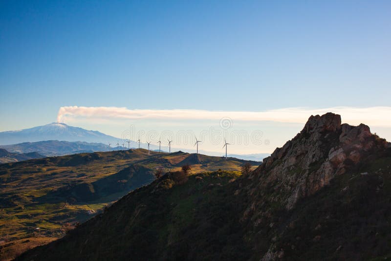 View of Windmills and the Mount Etna Volcano Stock Photo - Image of ...