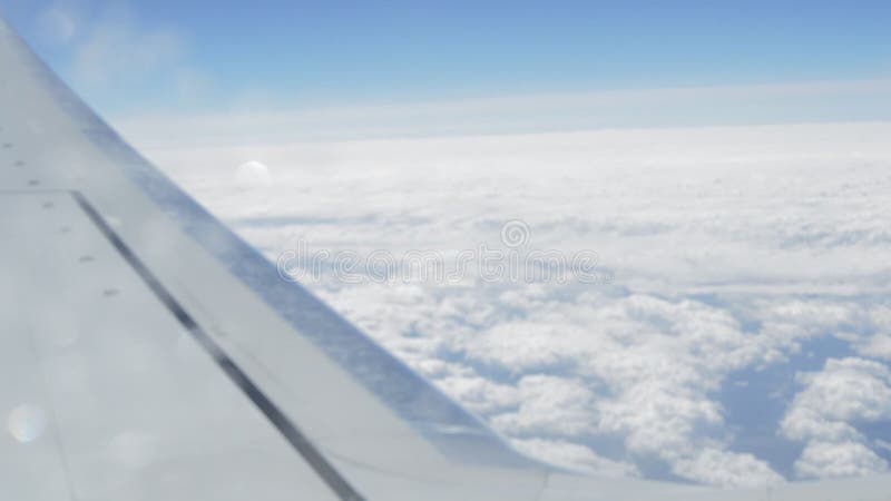 View through the Window of the Aircraft on the Clouds and the Wing, the ...