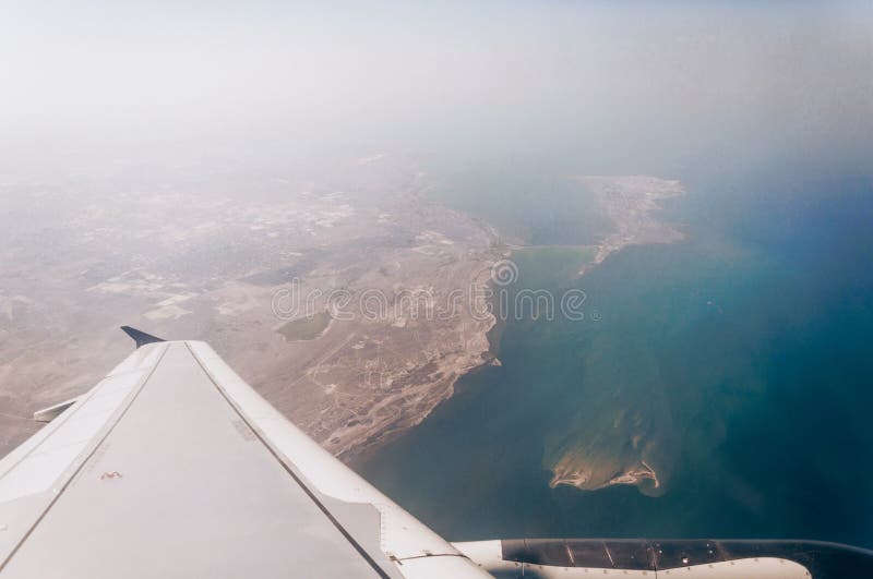 View from Window of Aircraft Window on Wing and Ground from Above Stock ...