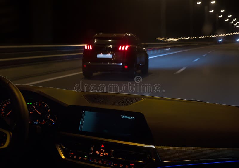 View through the Windshield of a Car on Traffic on a Night Road Stock ...