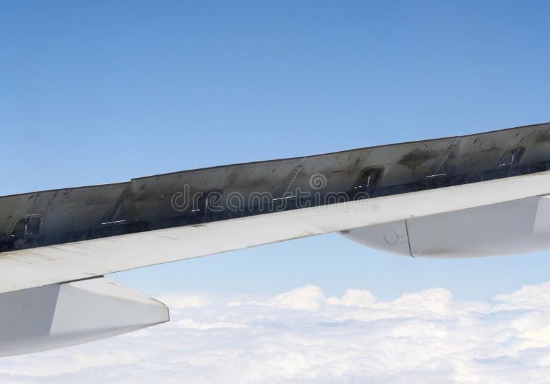 View of Wing of Airplane with Open Flaps from Window with Blue Sky ...
