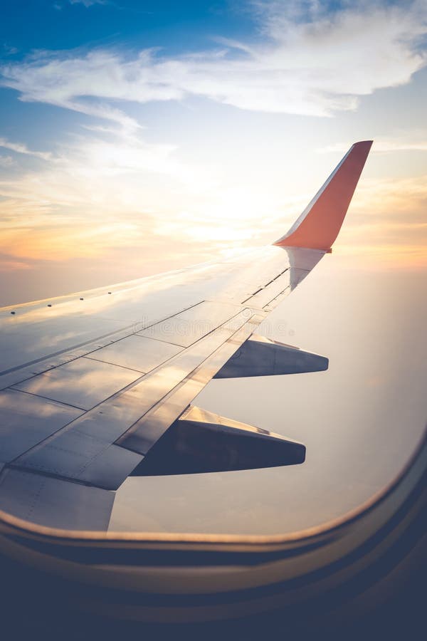 View of Wing from Window of an Airplane Stock Image - Image of clouds ...