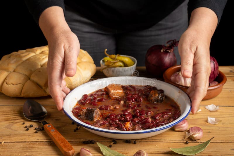 View of Woman S Hands with a Plate of Basque Beans on a Rustic Table ...