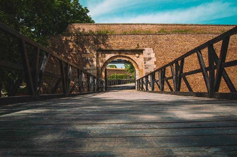 View of a Wooden Bridge Leading To the Arch of a Brick-built Wall Stock ...