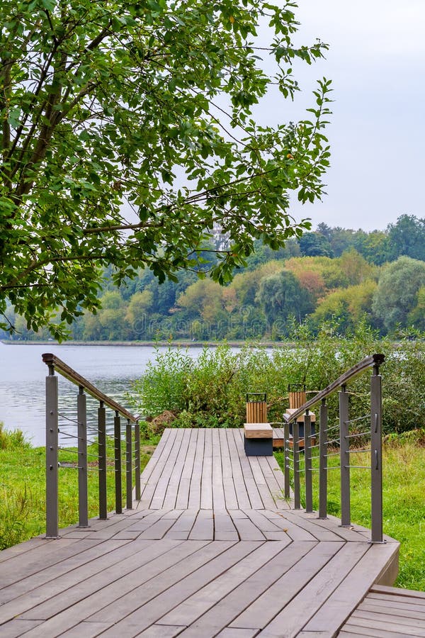 A Wooden Walking Path with Handrails in Park on the River Coast Stock ...