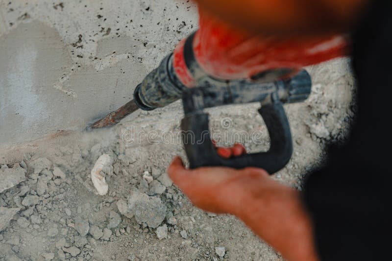 View of a Worker at a Construction Site Working with a Rock-drill and ...