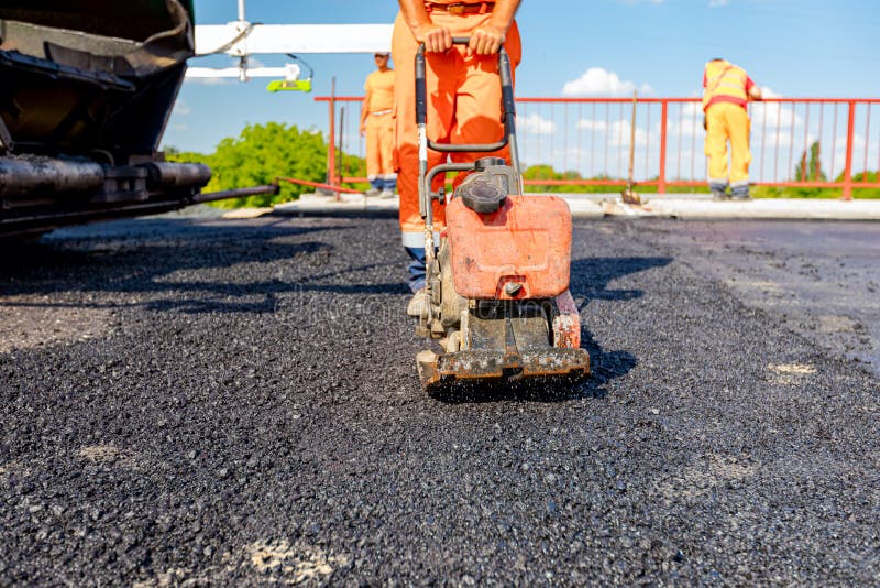 Worker Compacts Tarmac Using Vibration Plate Compactor Stock Photo ...