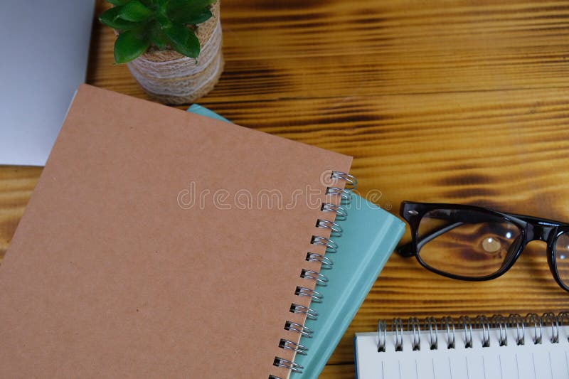 View of a Workplace with a Laptop and a Notebook, on a Wooden Table ...