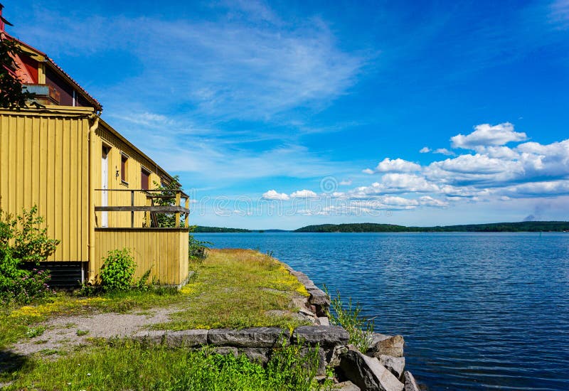 View of a Yellow Wooden Building by a Lake Stock Photo - Image of ...