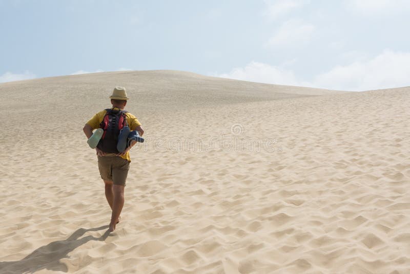 Young Man with Backpack Going in the Sandy Desert Stock Image - Image ...