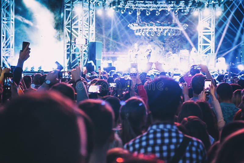 Viewers Watch a Rock Band Perform on Stage. Stock Photo - Image of ...