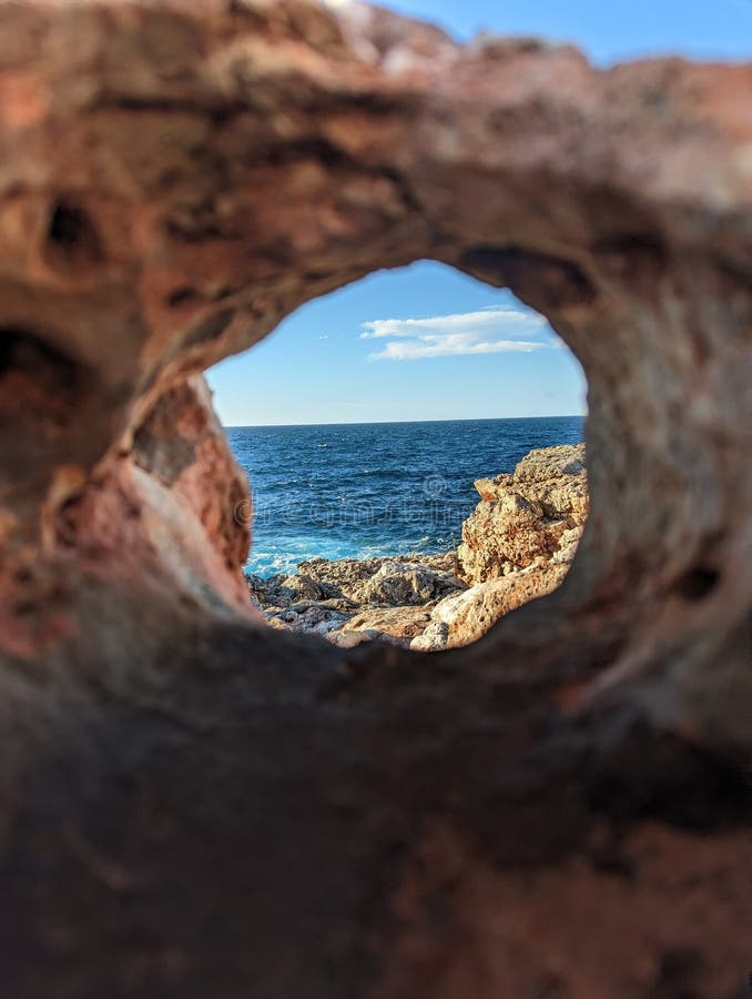 Viewing the Ocean through a Hole in the Rocks Stock Image - Image of ...