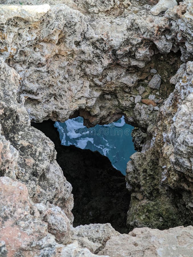 Viewing the Ocean through a Hole in the Rocks Stock Image - Image of ...