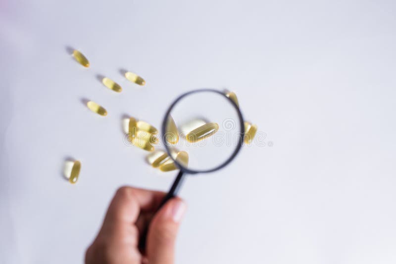 Viewing Tablets through a Magnifying Glass on a White Background Stock ...