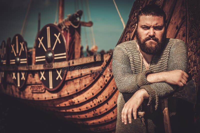 Viking with Axe Standing Near Drakkar on the Seashore. Stock Image ...