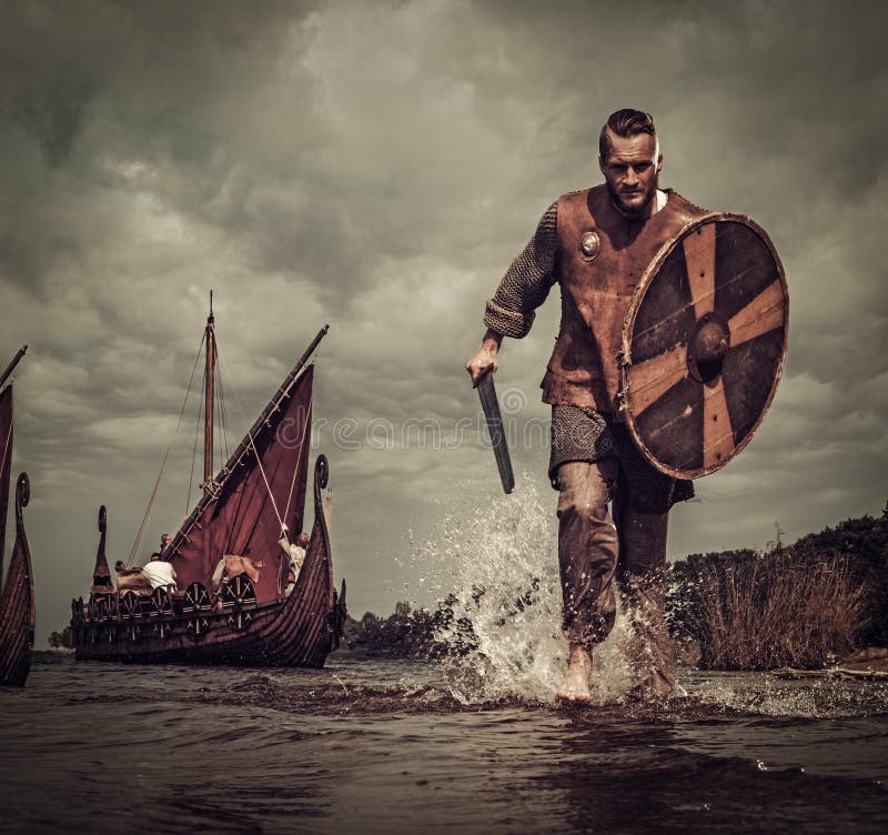 Viking Warrior in the Attack, Running Along the Shore with Drakkar on ...