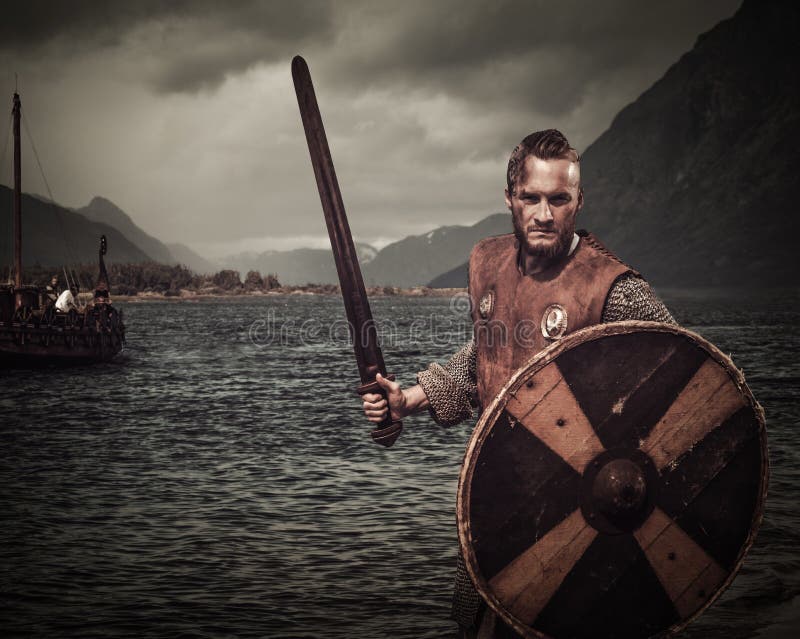 Viking Warrior in the Attack, Standing Along the Shore with Drakkar and ...
