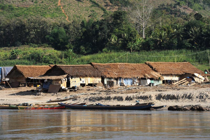 Village on a Bank of Mekong River Stock Photo - Image of plant, canoes ...
