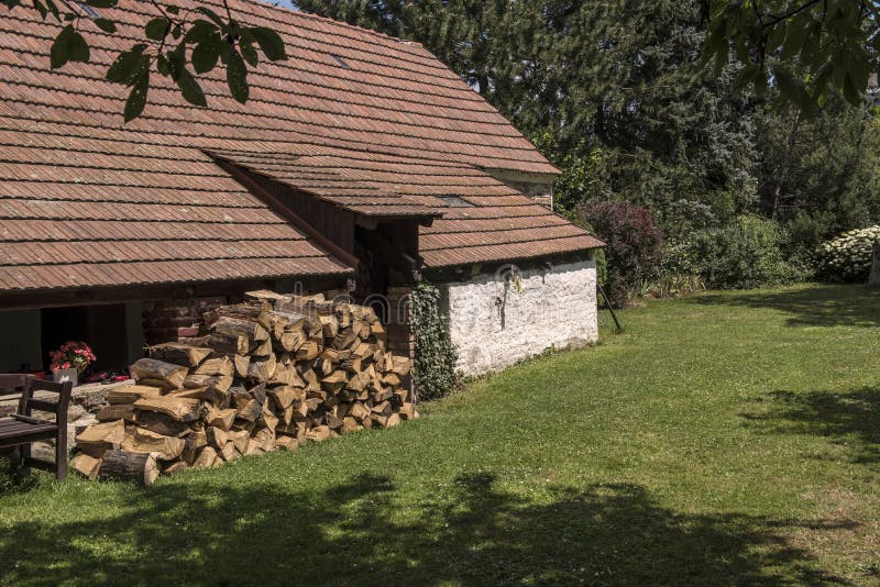 Village Cottage with Cut Wood Stock Photo - Image of rural, grass: 93264502