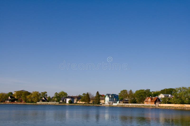 Village on shore of lake stock photo. Image of landscape - 5150024