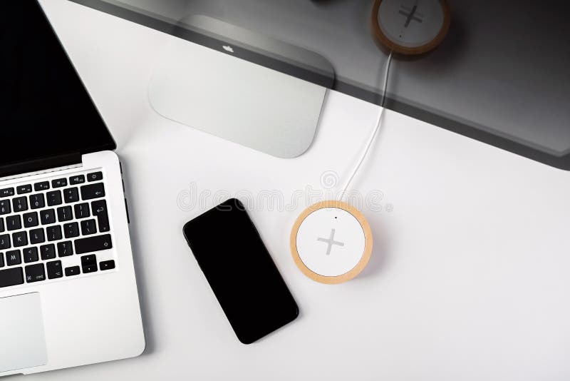 IPhone X Smart Phone and Wireless Charger on Working Table Editorial ...