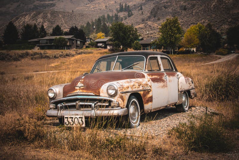 Vintage Abandoned Rusty Car in a Field Under the Sunlight in the ...