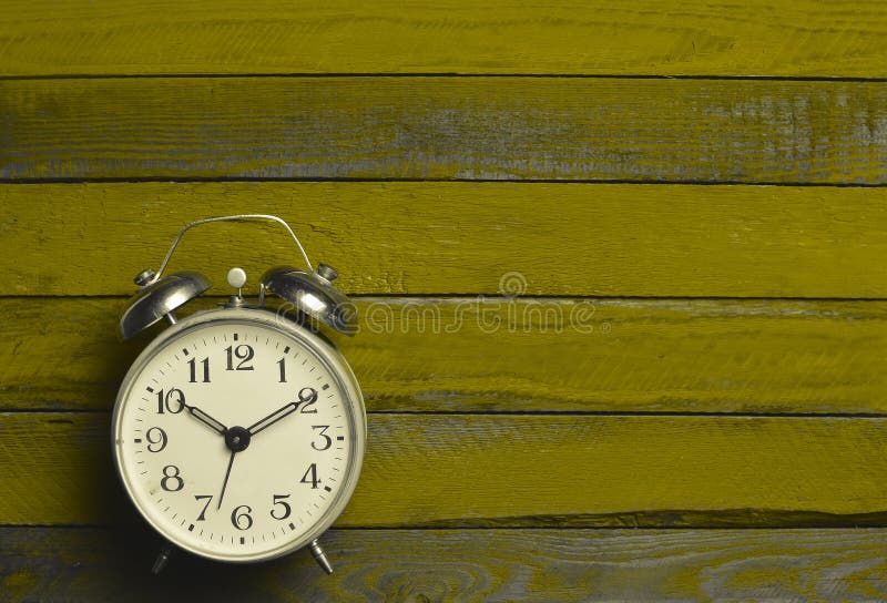 A Vintage Alarm Clock on a Colored Wooden Table. Top View Stock Image ...