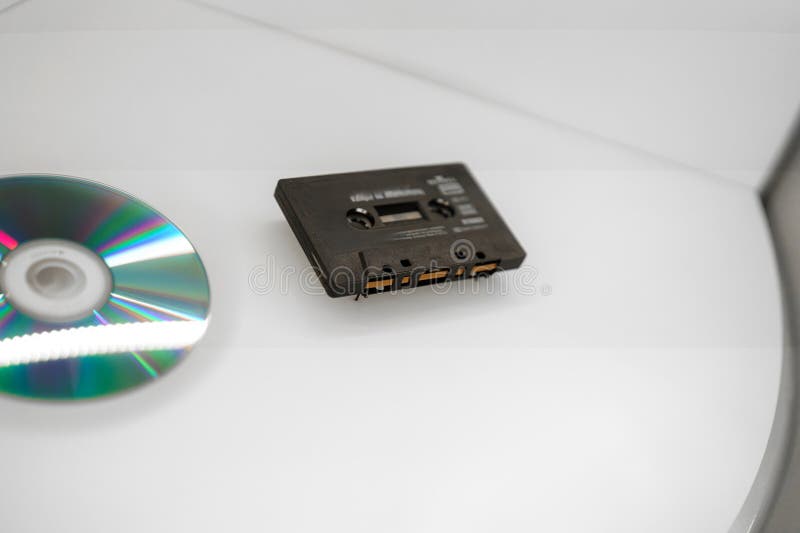 Vintage Audio Cassette and Compact Disc on a Reflective Surface ...