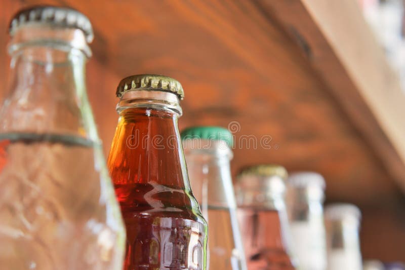 Vintage Beverage Bottles with Colorful Caps on Bar Shelf Create a ...
