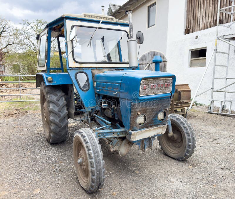 Vintage Blue Tractor on Farm with Weathered Exterior and Rustic Charm ...