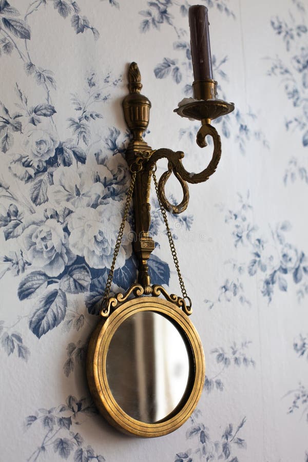 Vintage Candlestick with a Mirror Hanging on the Wall Stock Image ...
