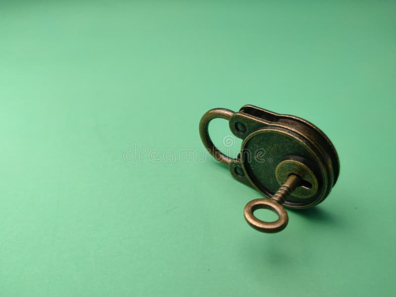 Vintage Bronze Key and Padlock on Soft Green Paper Stock Photo - Image ...