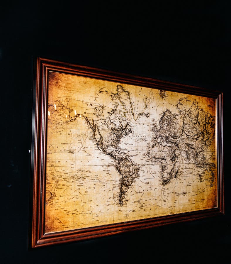Vintage Burnt World Map in a Frame on a Black Wall. Interior Element ...