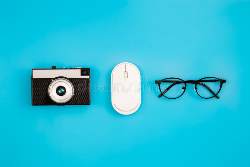 Vintage Camera, Glasses and Computer Mouse on a Blue Background ...