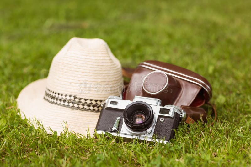 Vintage Camera with His Cover Near a Straw Hat Stock Photo - Image of ...