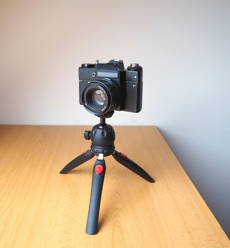 Vintage camera on a table stock photo. Image of tripod - 172681178