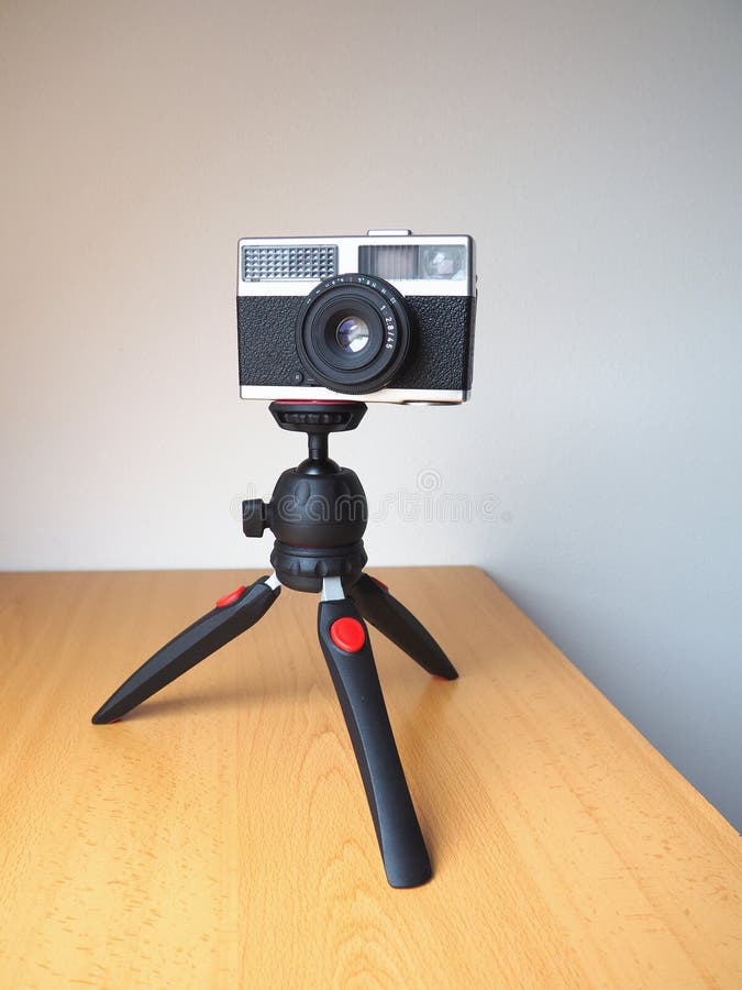 Vintage camera on a table stock photo. Image of tripod - 172681178