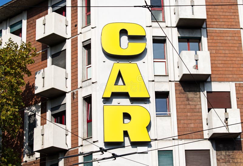 Vintage CAR Yellow Sign on a City Building Stock Photo - Image of ...
