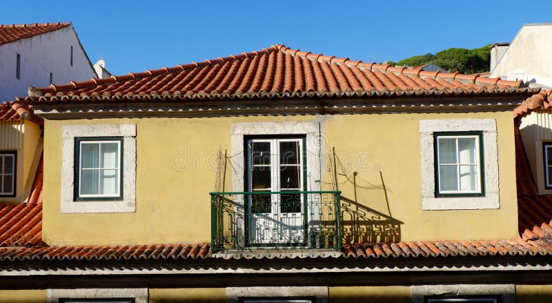Vintage Classical Building with Tiled Roof, Windows and Balcony. Roof ...