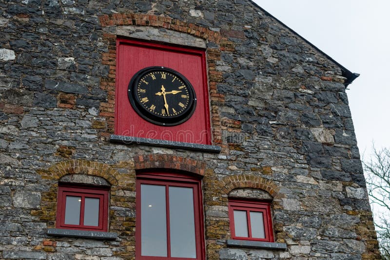 Vintage Clock with Arrows on the Wall of Old Stone House Stock Image ...