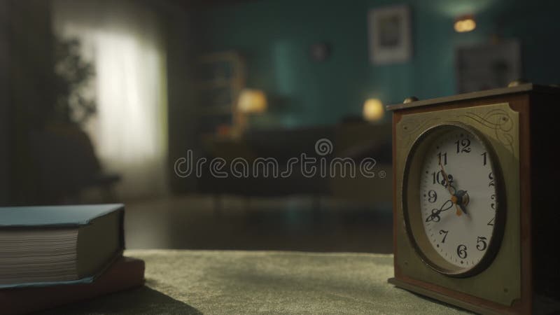 Vintage Clock Stands on a Table in a Dark Room Close Up. the Clock Hand ...