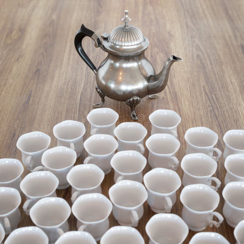 Vintage Coffee Pot on Wooden Surface with Many White Cups Stock ...