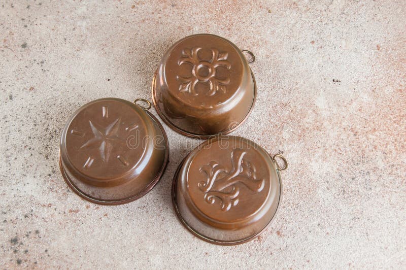Vintage Copper Molds on a Concrete Background Stock Image - Image of ...